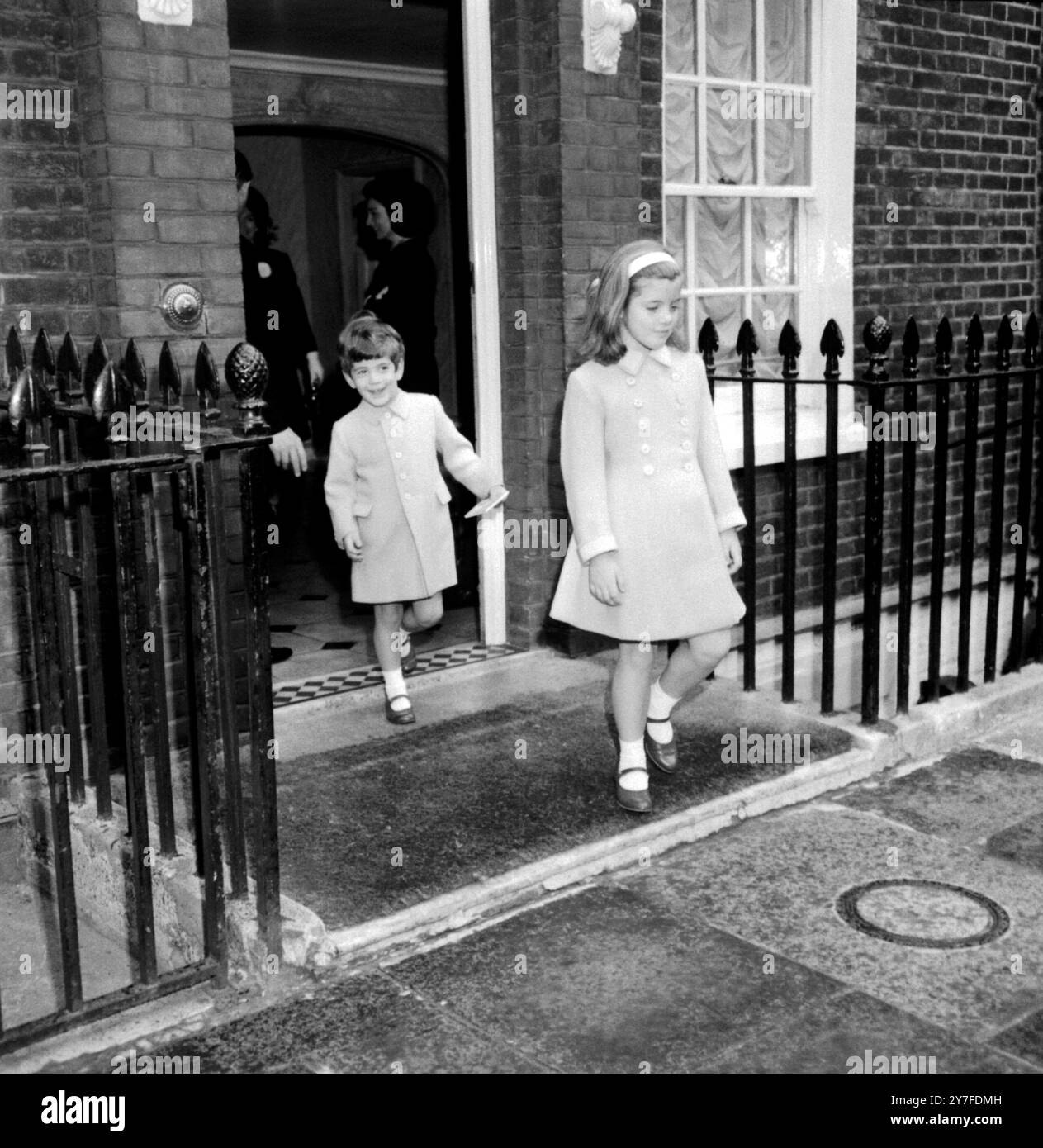 Miss Caroline Kennedy, followed by her brother John are pictured ...