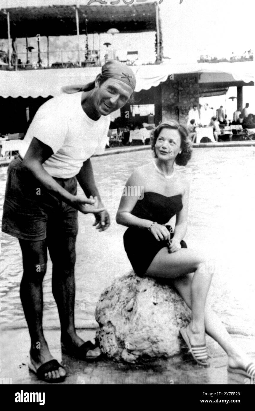 Curvaceous screen actress Simone Simon gets information from a typical ...