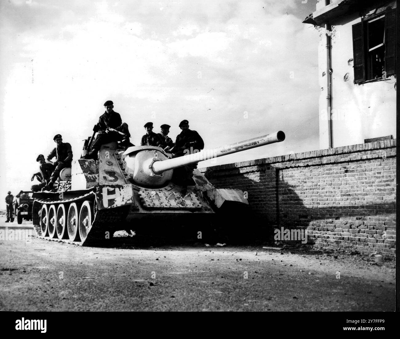 British Commando Troops sit on a captured Russian Tank which was manned ...