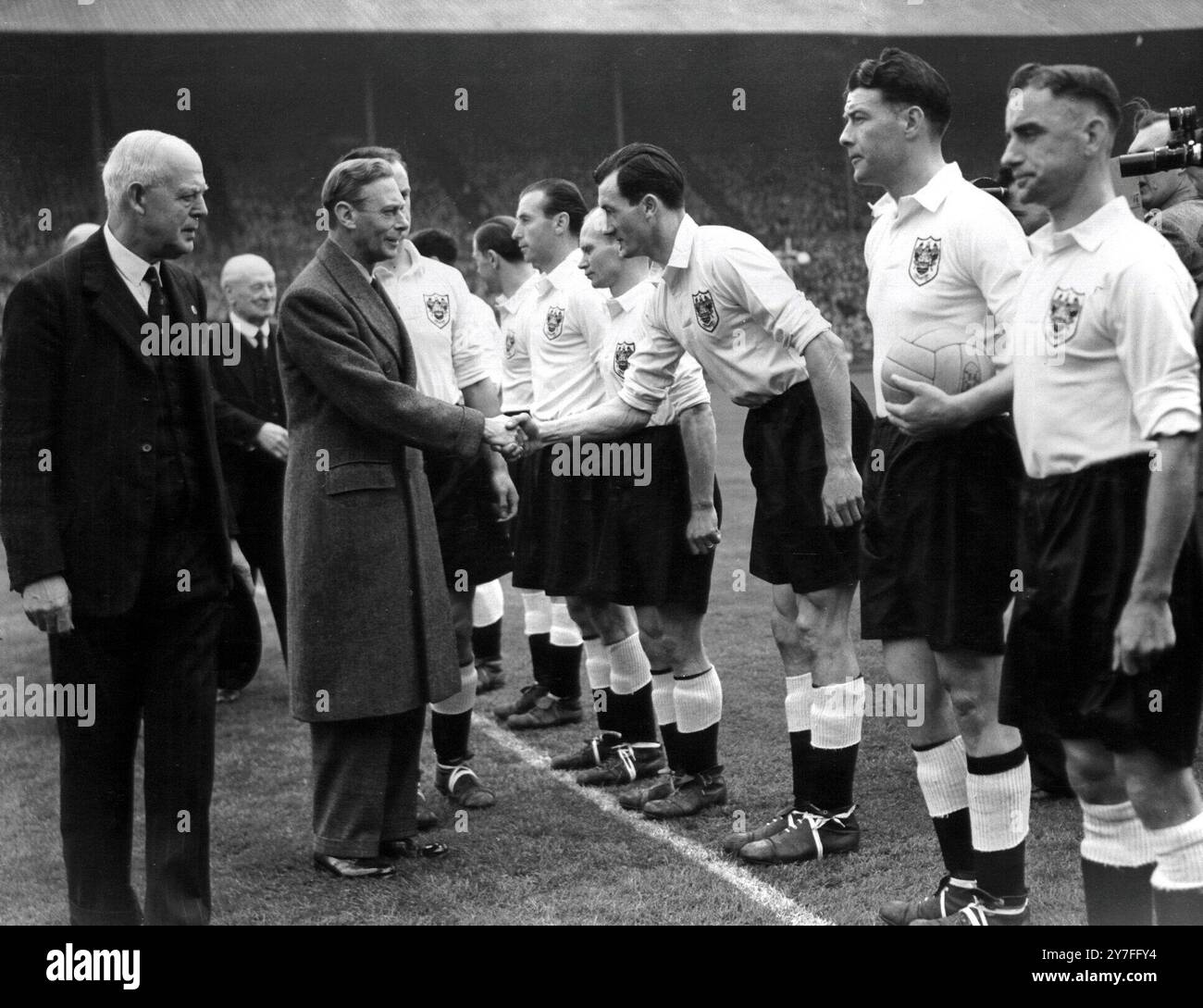 King George VI shakes hand with members of the Blackpool Football Team ...