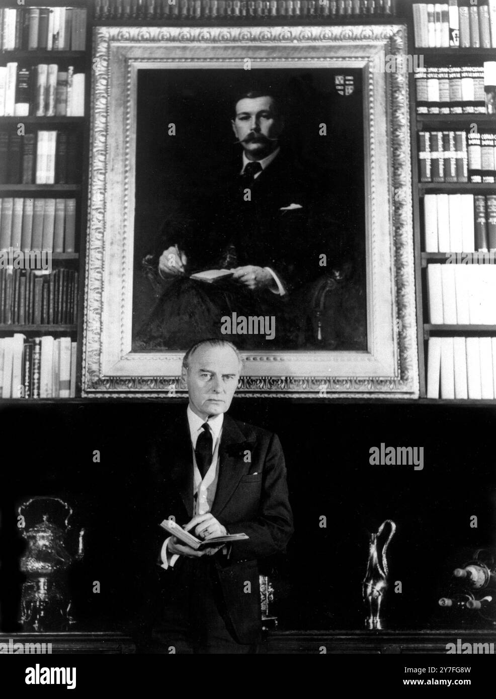 Adrian Conan Doyle stands in front of a portrait of his father Sir ...