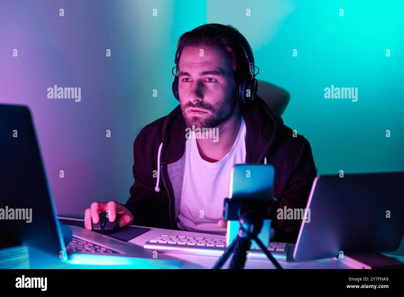 Concentrated young man looking at the computer monitor during live ...