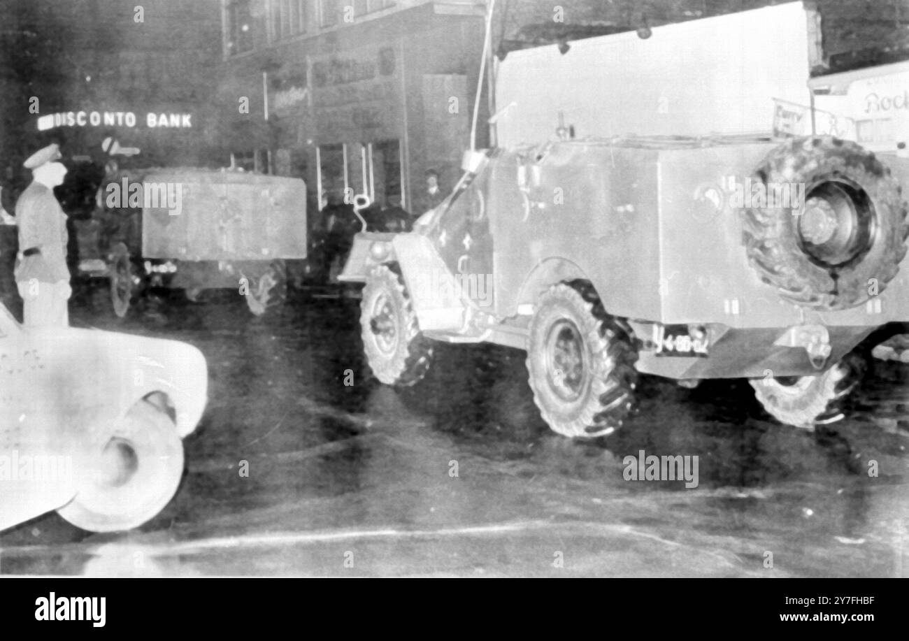 Two Soviet armoured cars speed through Checkpoint Charlie carrying the ...