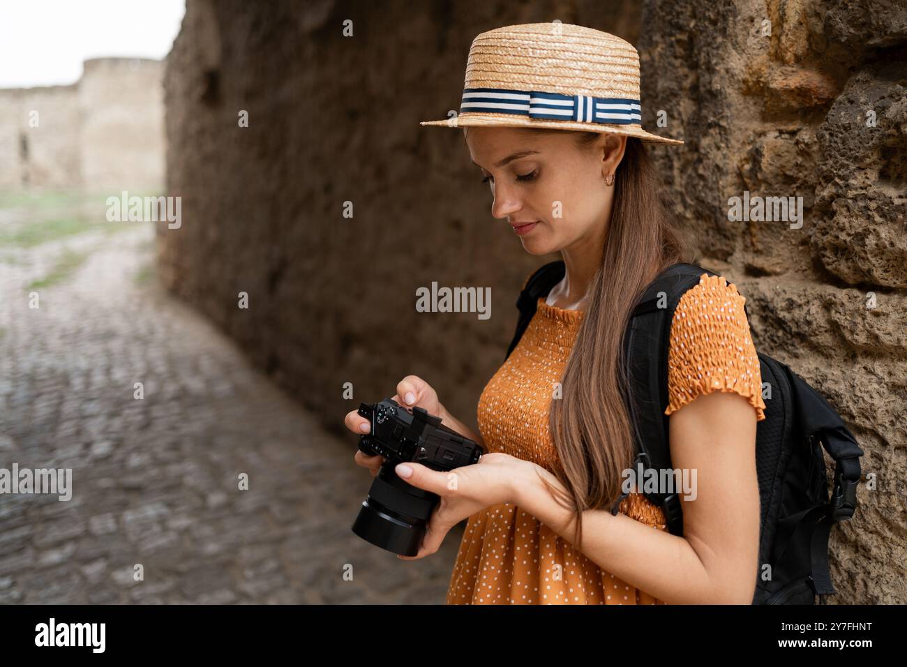 Woman traveler documenting her journey inside an old castle, capturing ...