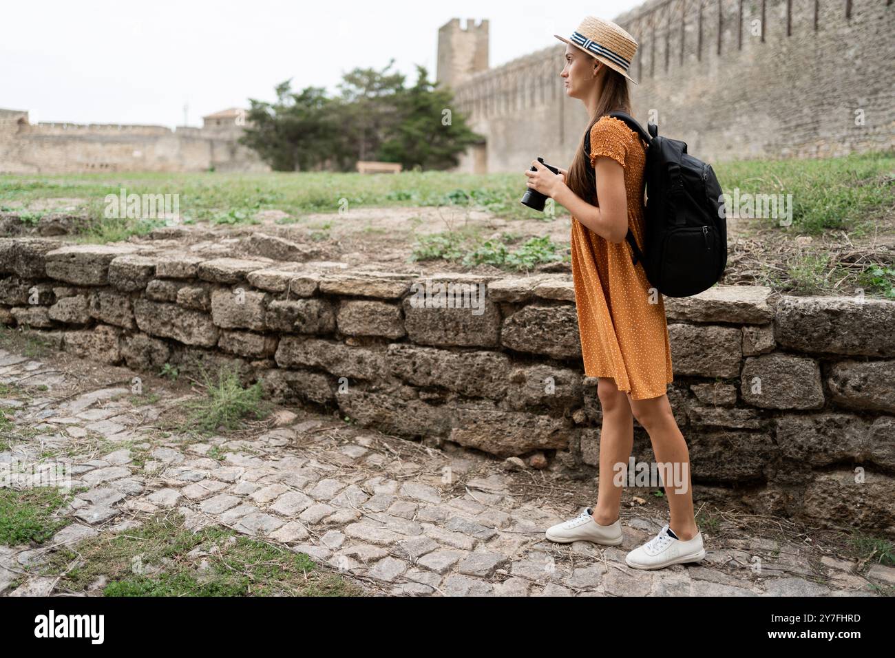 Woman exploring medieval castle with camera, photographing historic ...