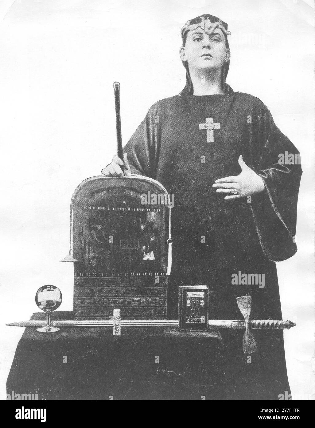 Aleister Crowley at his altar, magically robed and crowned with the ...