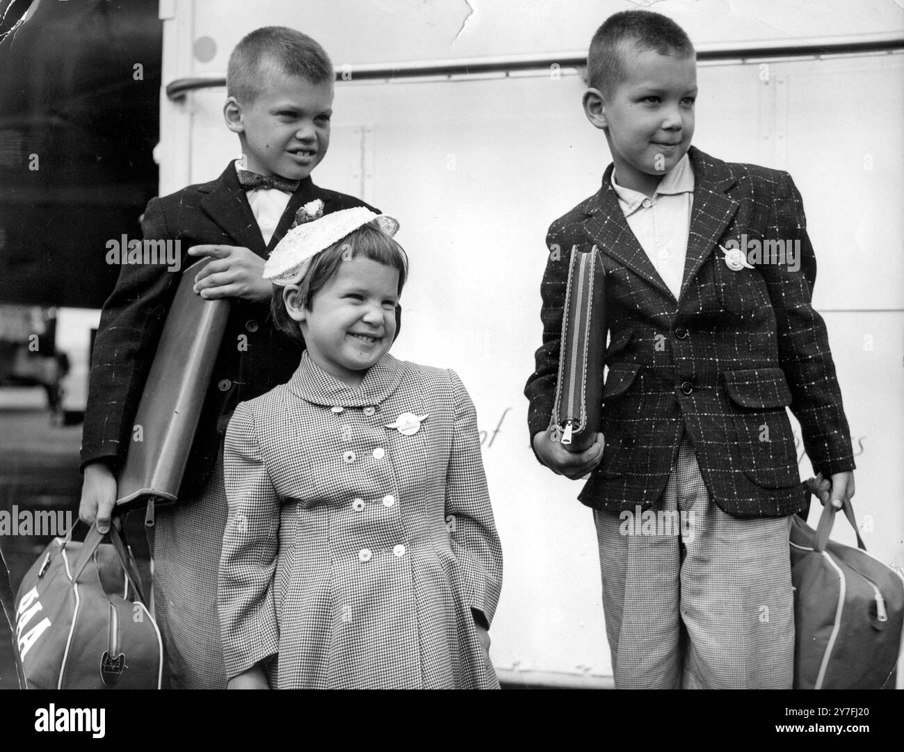 Three young air travellers who arrived at London Airport from America ...