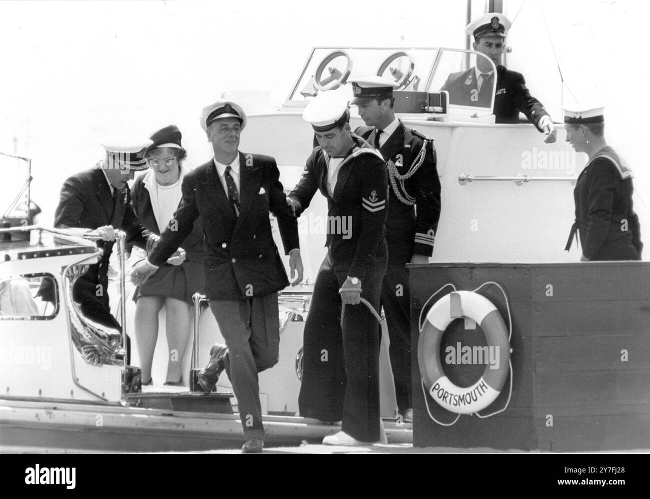 LONE ROUND-THE-WORLD YACHTSMAN ALEC ROSE STEPS ASHORE FROM AN ADMIRALTY ...