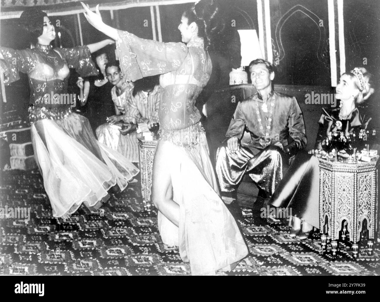 The lady on the right, watching the dancing girls is heiress Barbara ...
