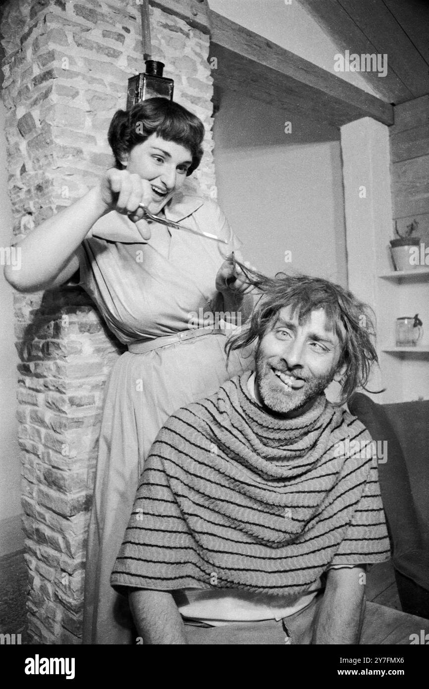 Spike Milligan gets a haircut, at home in north London with his first ...