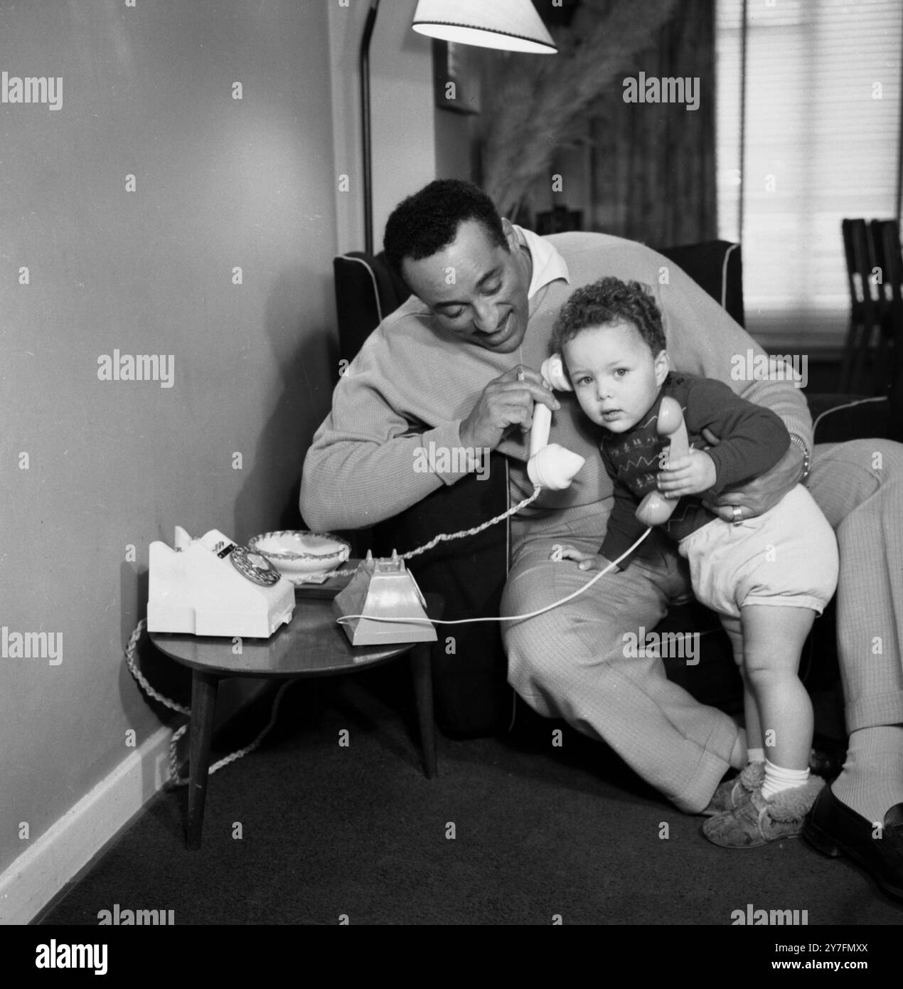 Ray Ellington, 1915-1985, at home in London with his son Lance by wife ...