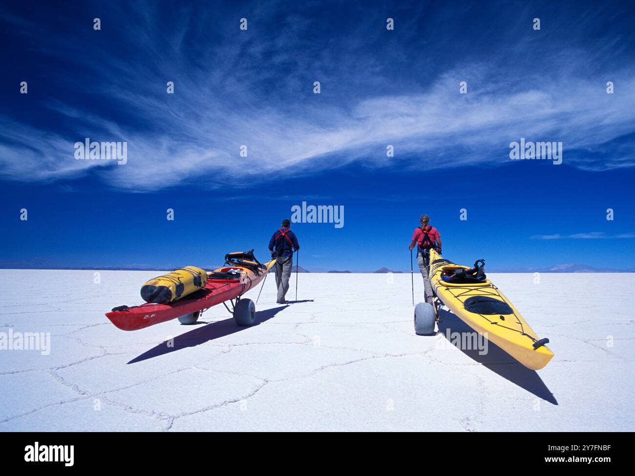 Two kayakers pulling kayaks on salt flats, Alitplano Stock Photo - Alamy