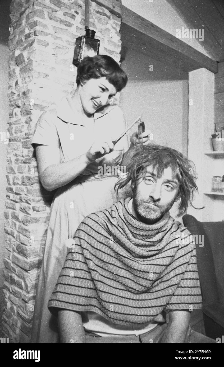 Spike Milligan gets a haircut, at home in north London with his first ...