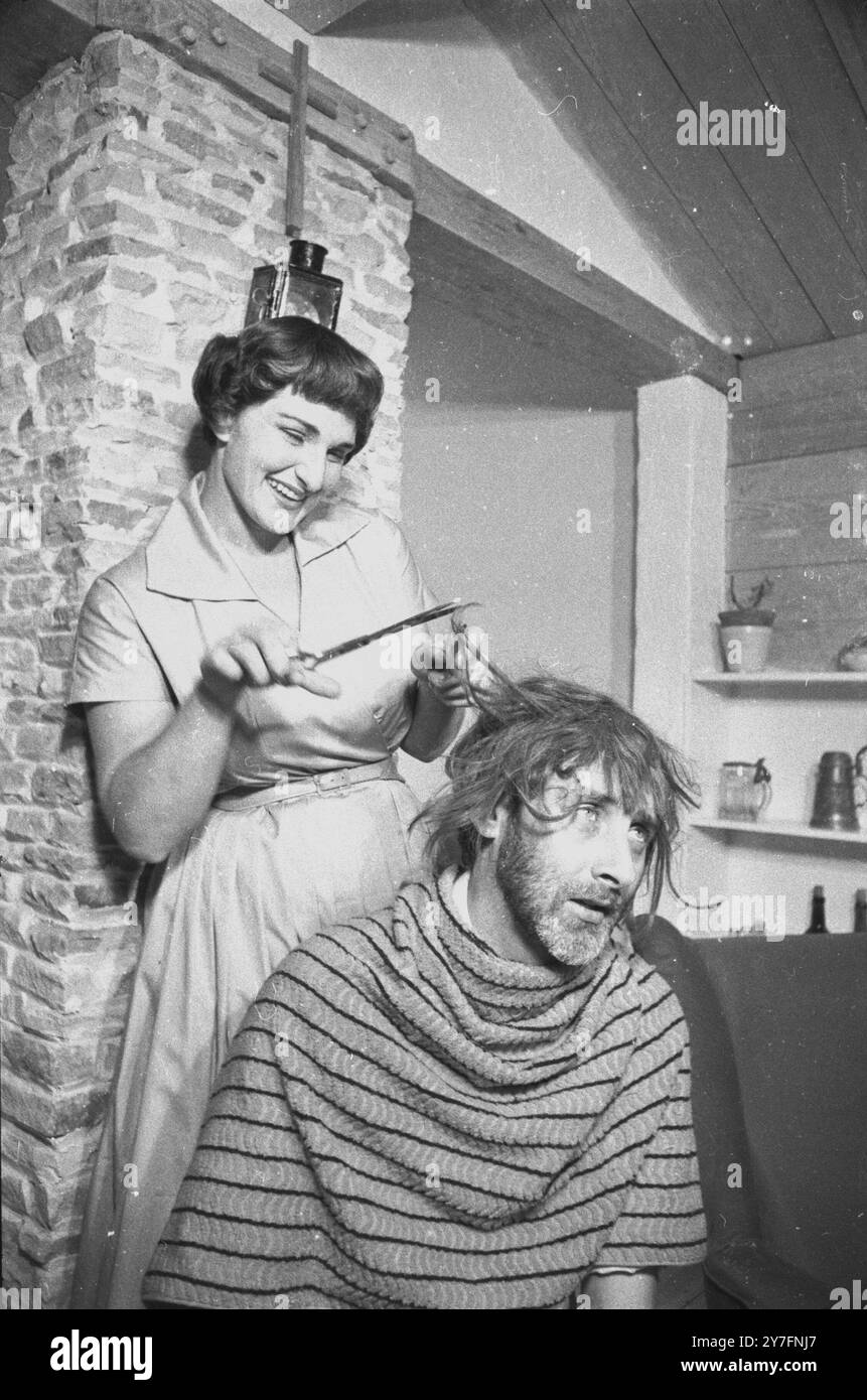 Spike Milligan gets a haircut, at home in north London with his first ...