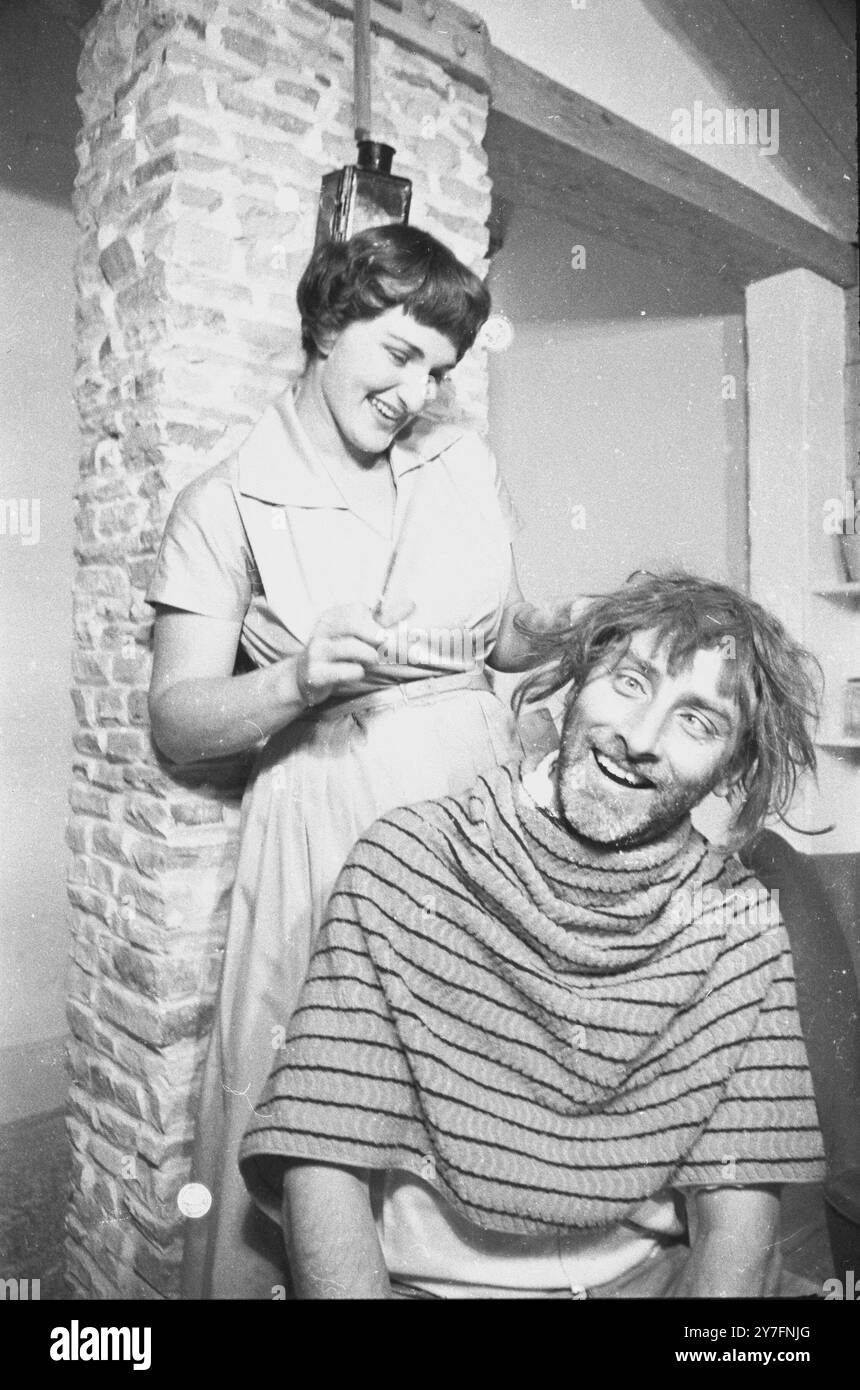 Spike Milligan gets a haircut, at home in north London with his first ...