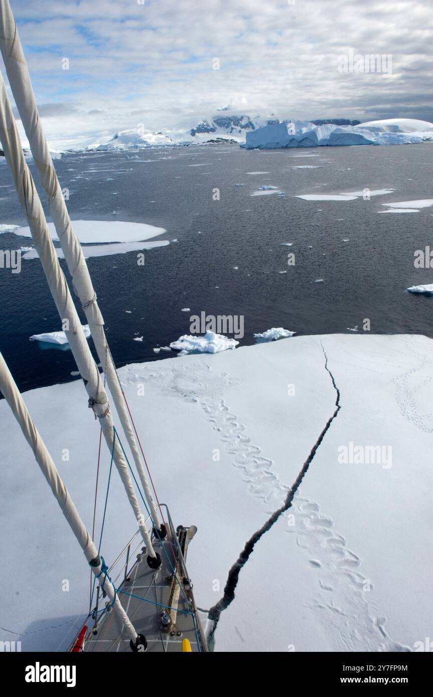 The bow of a sailing boat breaks through an ice sheet in the west coast ...