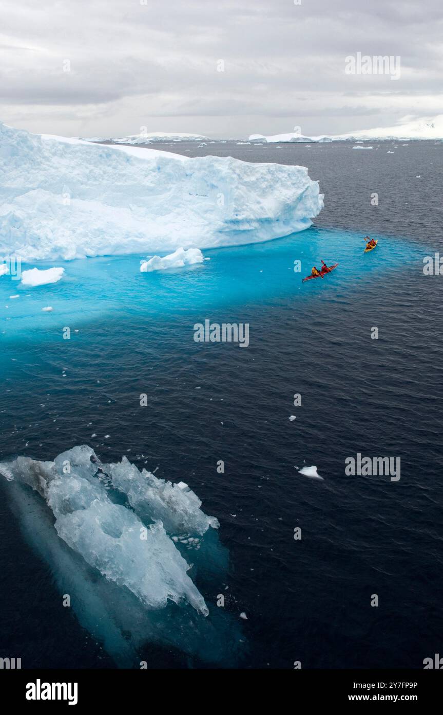 A group of kayakers paddle through the west coast of Antarctica's ...