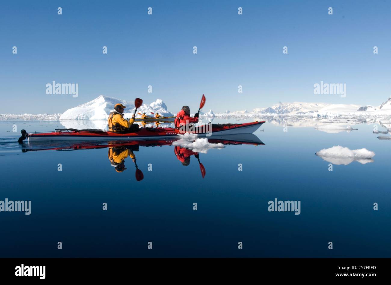 Kayakers paddle through the pristine waters in the west coast of ...