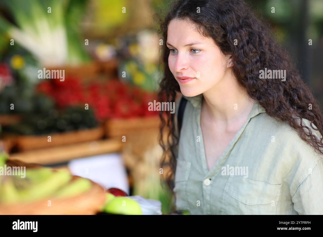 Client in a greengrocery looking standing at products Stock Photo - Alamy
