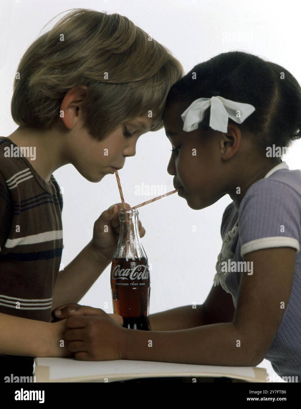 Children drinking coke from straws in a bottle Stock Photo - Alamy
