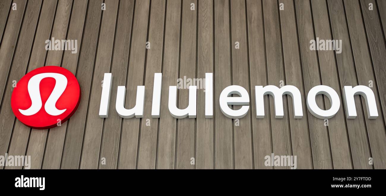 The Lululemon store corporate logo in red and white on a wooden ...