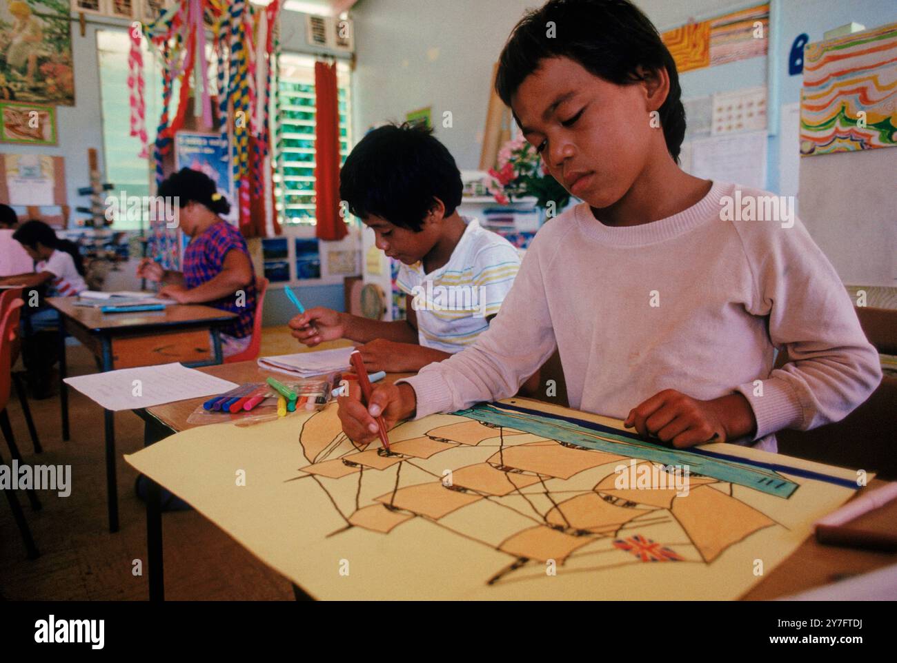 Children at school, one drawing a sailing ship. Tubuai Island, French ...