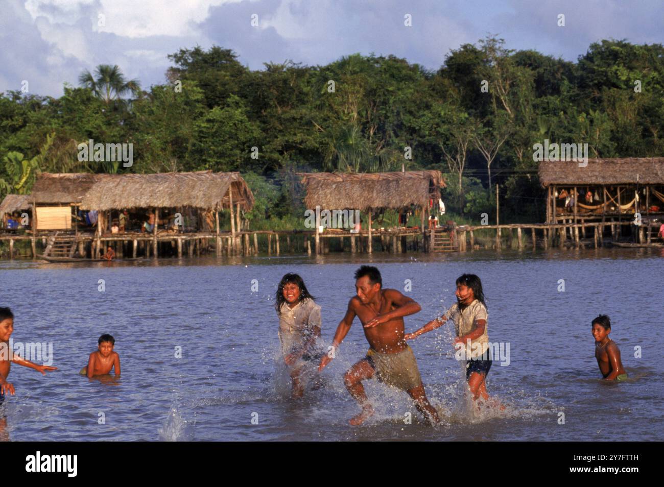Warao Indians play in water of low tide in Orinoco Delta, Venezuela ...