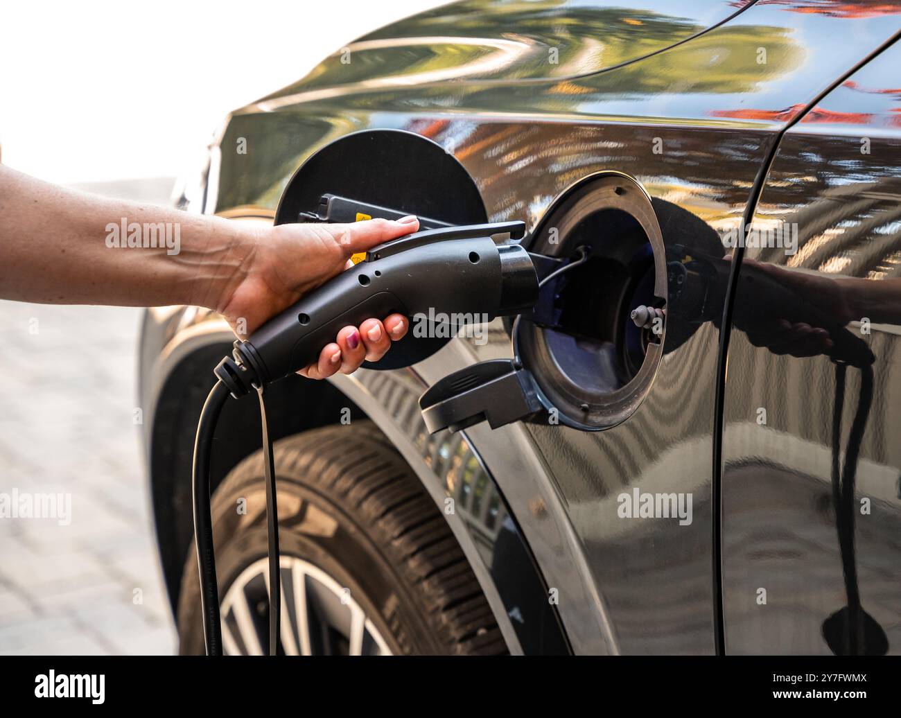 Hand using ev charger hi-res stock photography and images - Alamy