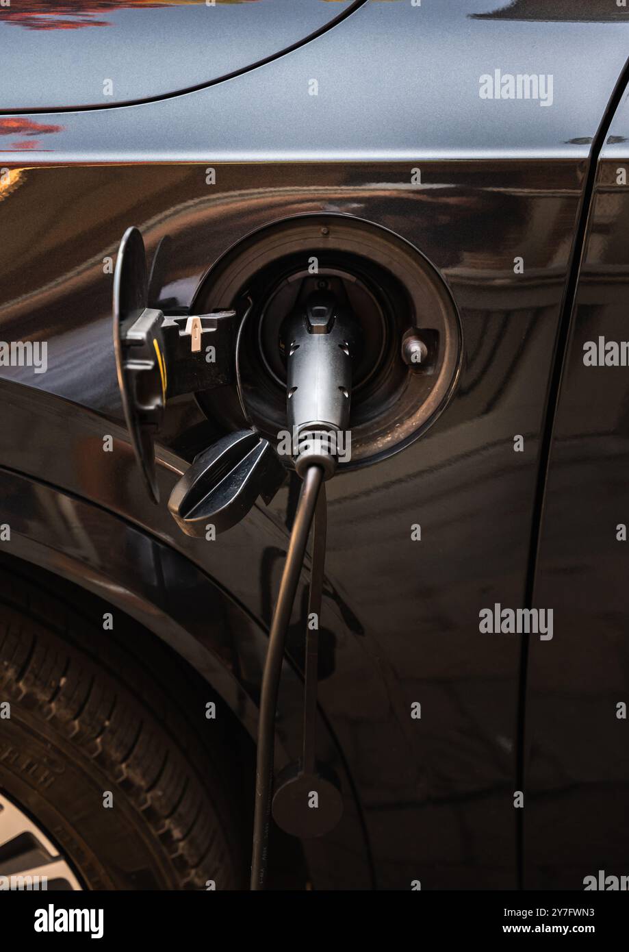 Close up of EV charger plugged into electric vehicle outside Stock ...