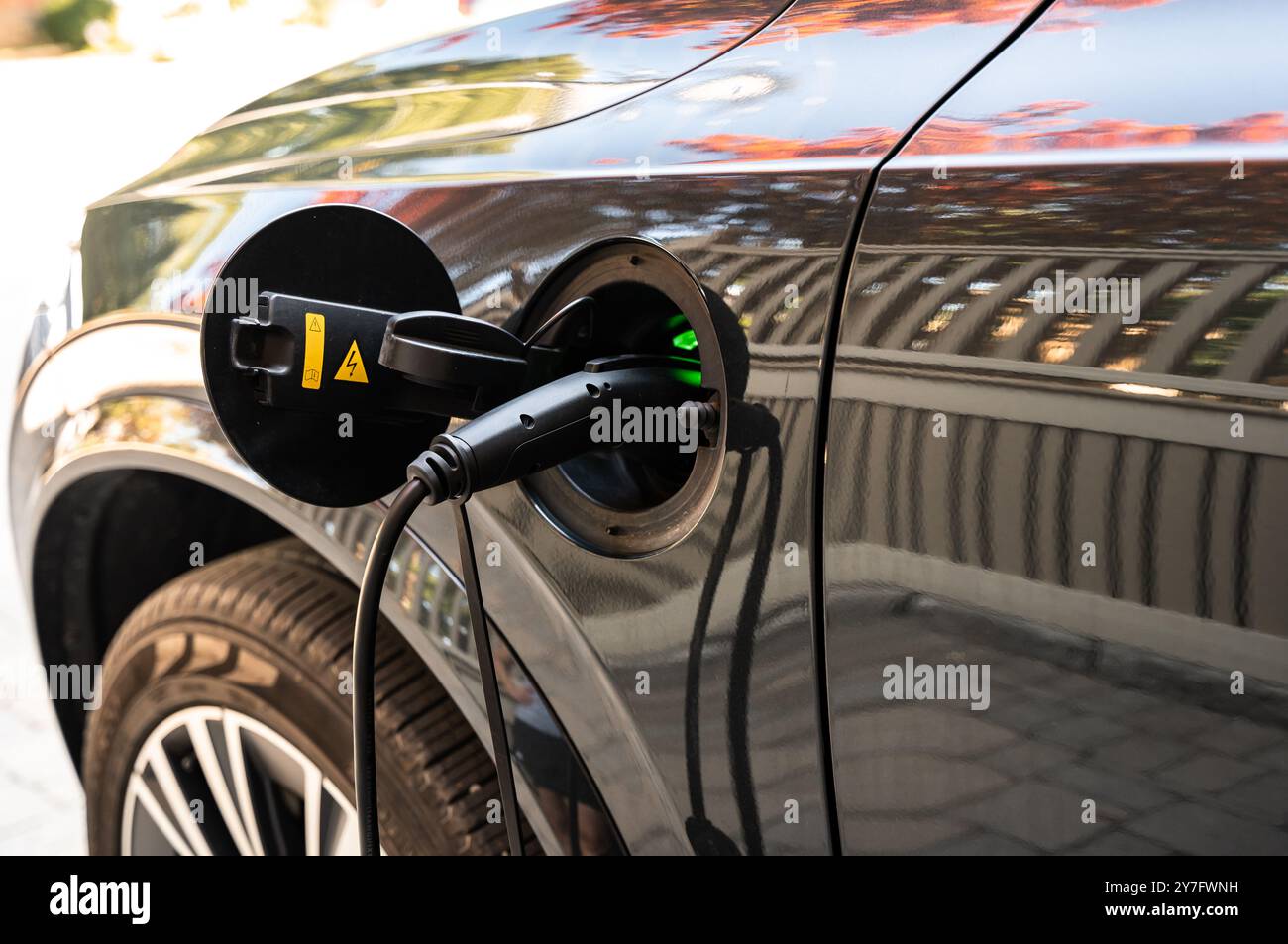Close up of EV charger plugged into electric vehicle outside Stock ...