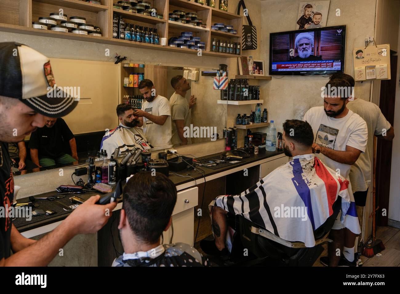 People listen to a speech by Hezbollah's deputy leader Sheik Naim ...