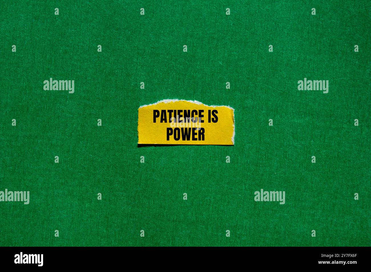 Patience is power message written on ripped torn yellow paper piece ...