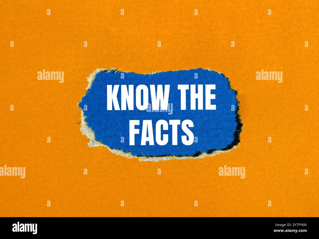 Know the facts message written on ripped torn orange paper with blue ...