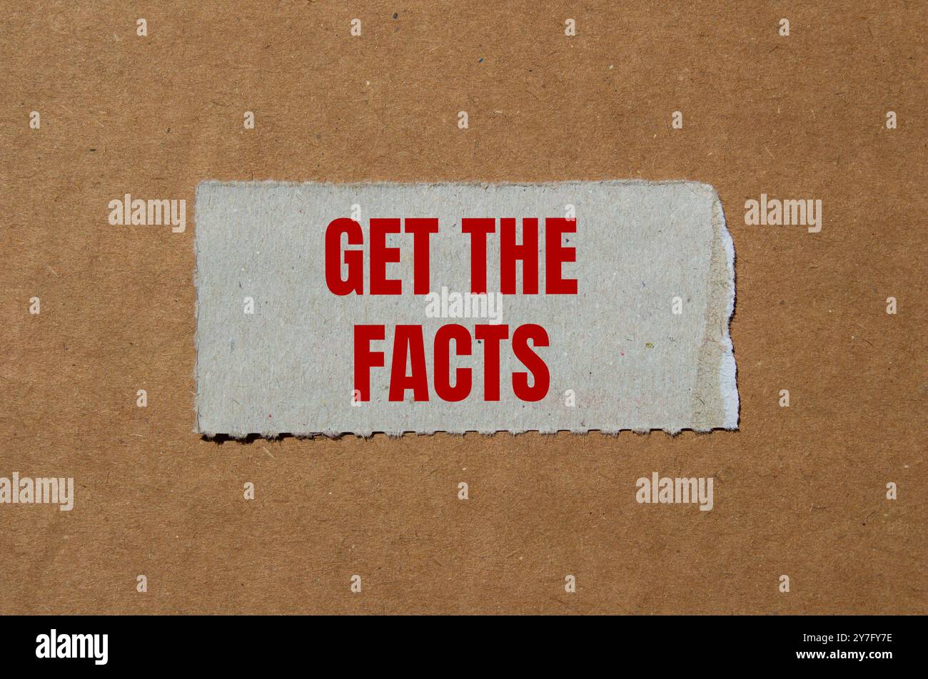 Get the facts message written on ripped torn paper piece with cardboard ...