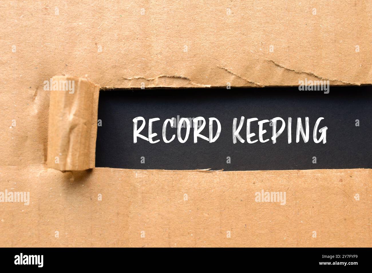 Record keeping message written on ripped torn cardboard paper with black background. Conceptual ...