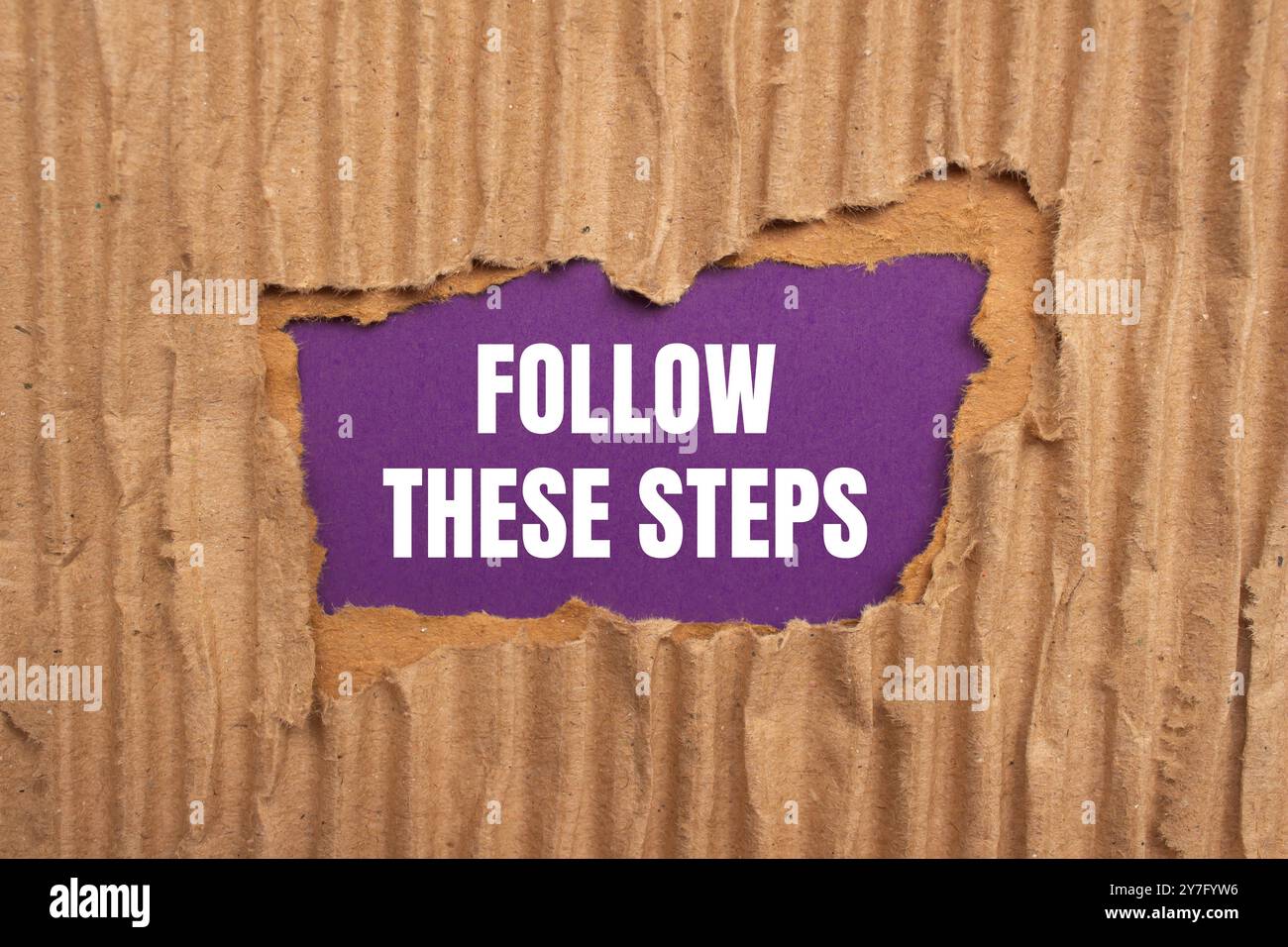Follow these steps message written on ripped torn cardboard paper on ...