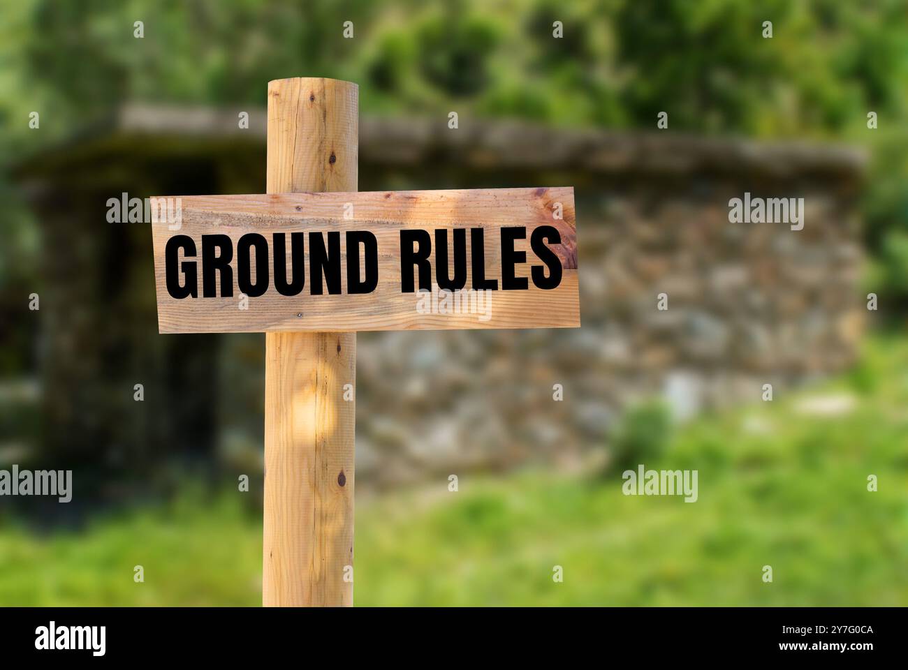 Ground rules message written on wooden sign with nature background ...