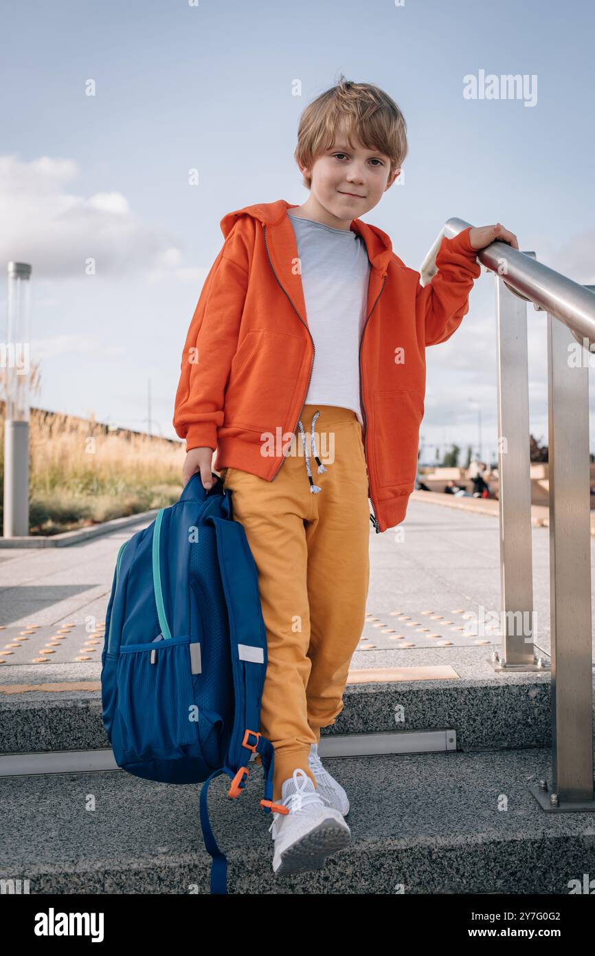 Little boy with backpack going to school, front view Stock Photo - Alamy