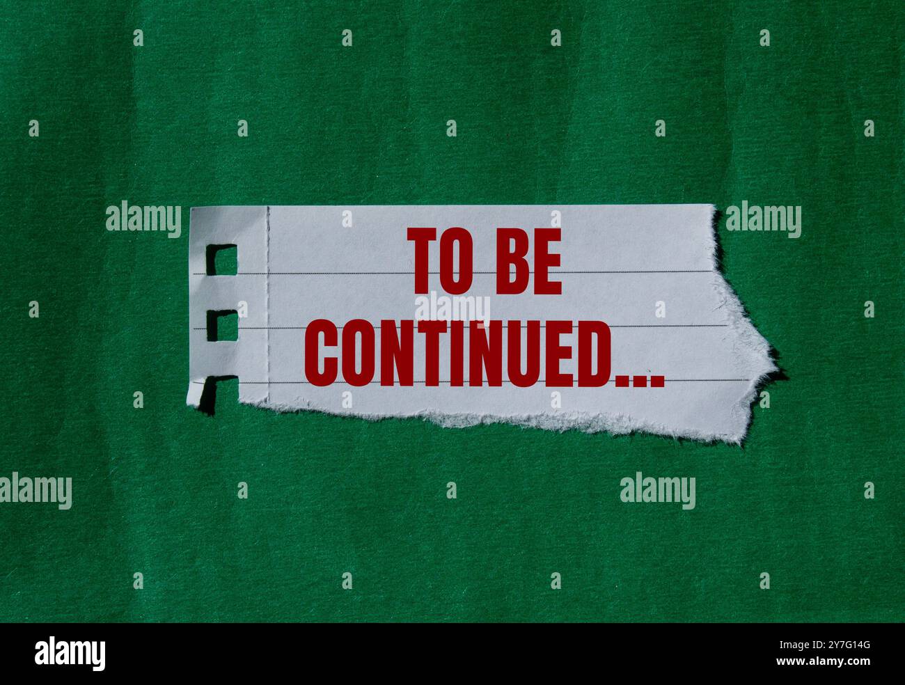 To be continued message written on ripped torn paper with green ...