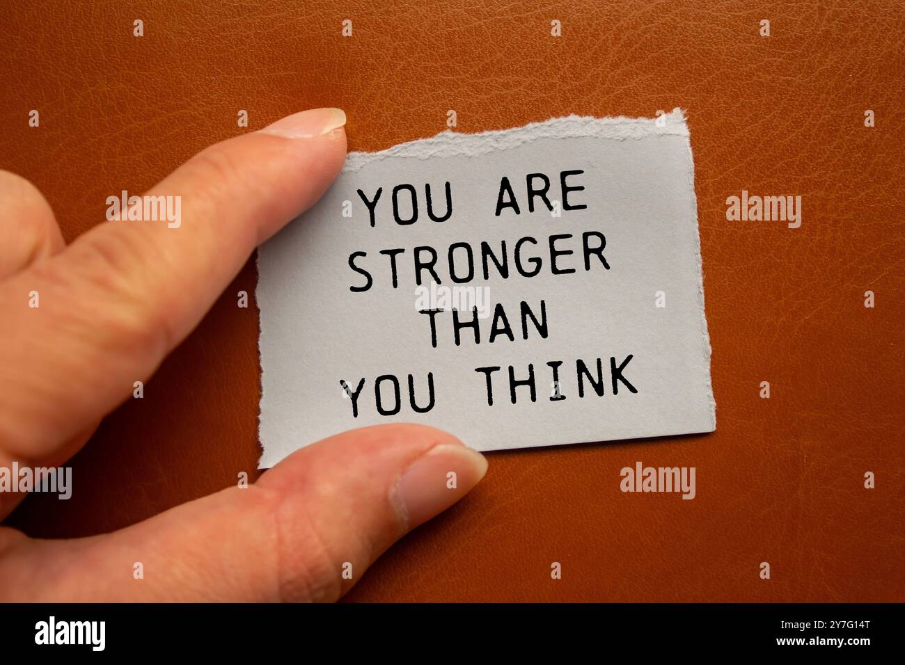 You are stronger than you think message written on ripped torn paper ...
