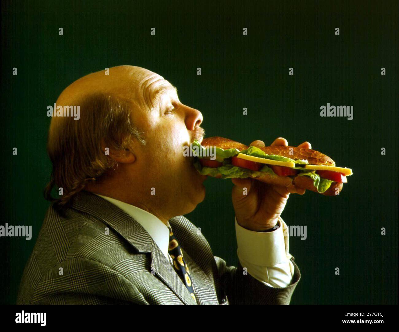 man eating large roll filled Stock Photo - Alamy