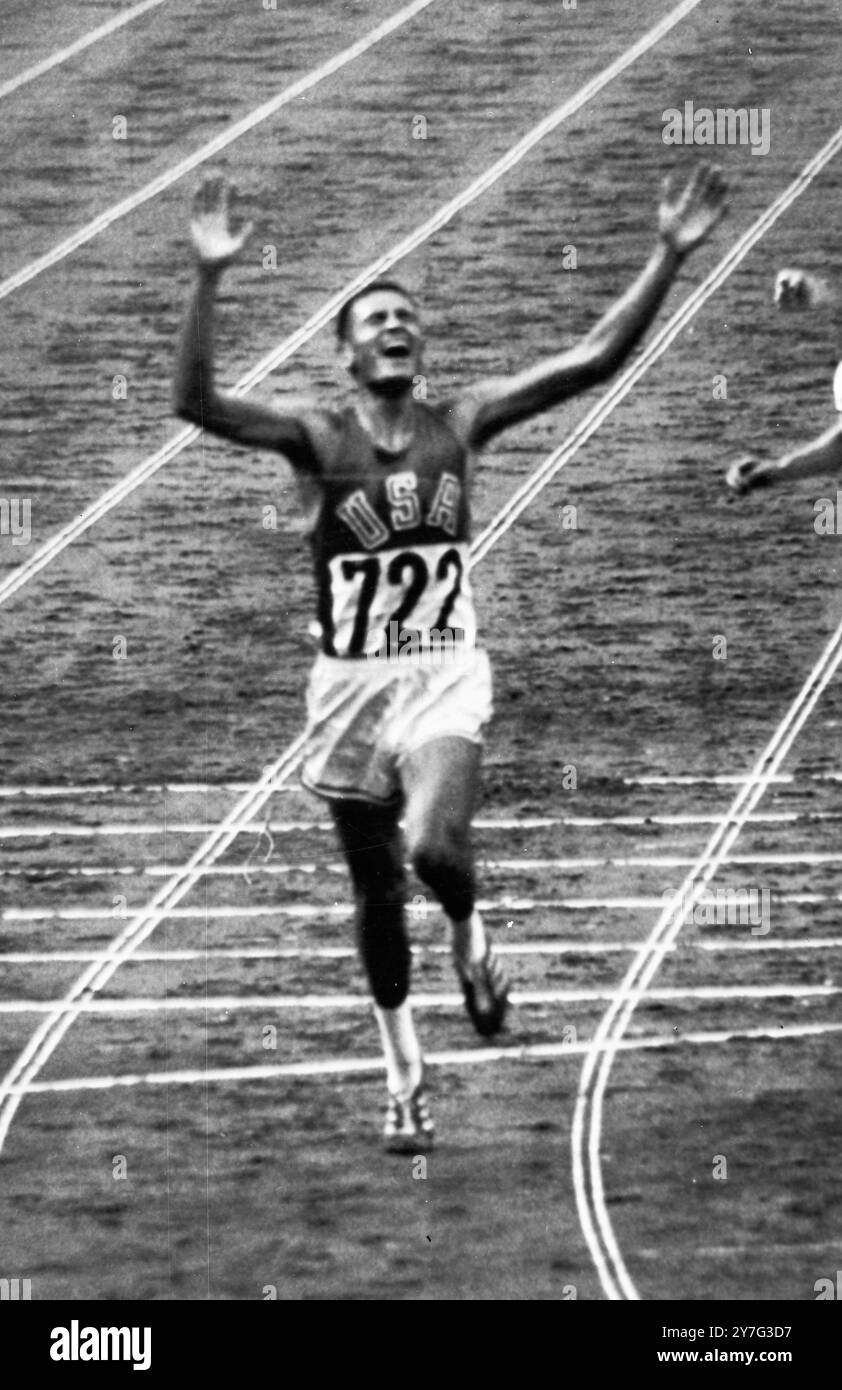 26 year old marine Billy Mills leaps as he crosses the finish line of ...