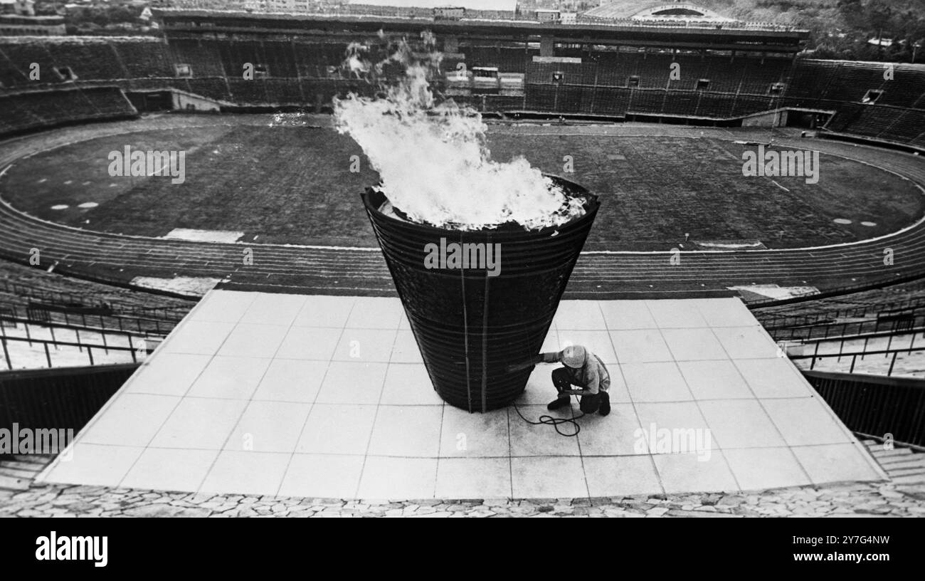 Flames burst forth from the huge Olympic cauldron atop the newly built ...