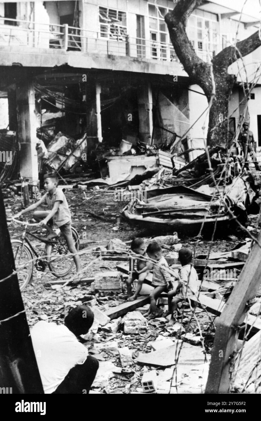 VIETNAM WAR YOUNGSTERS SIT IN RUBBLE OF BOMBED QUARTERS IN SAIGON ; 30 ...