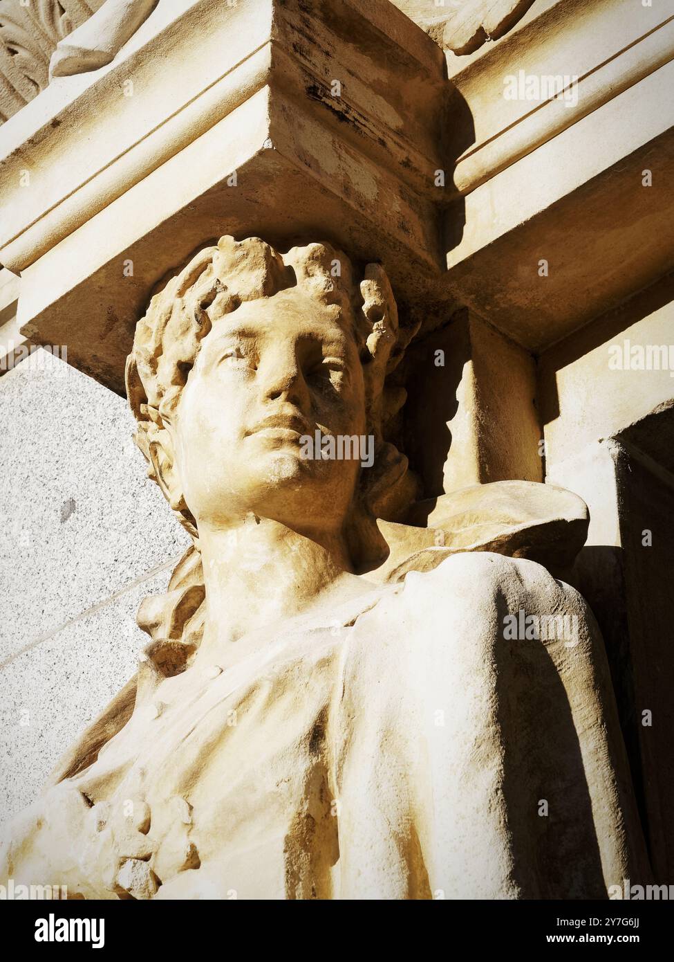 Close-up of a detailed stone statue on a historic building facade ...
