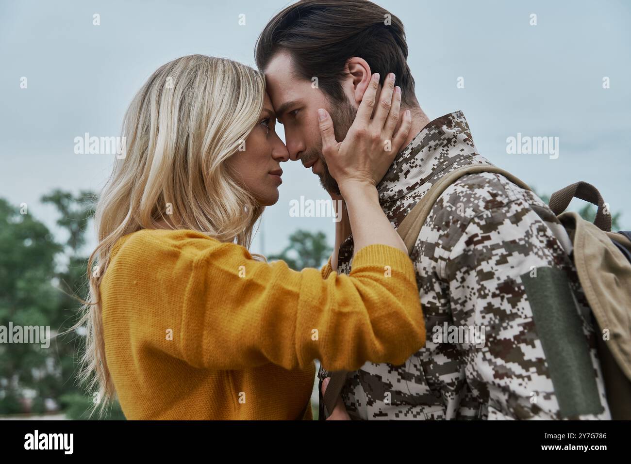 Beautiful young woman standing face to face with her husband before his ...