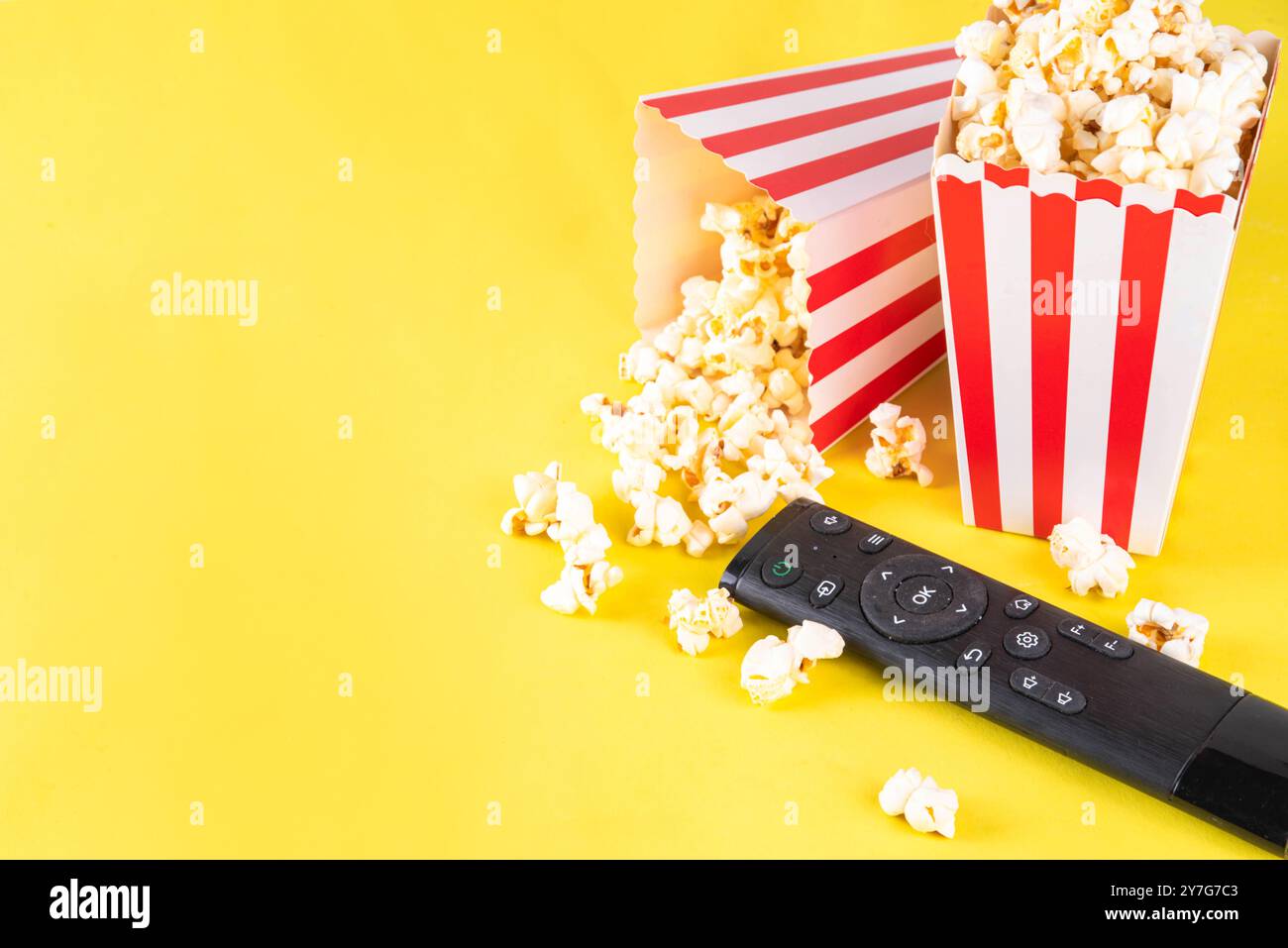 Paper bowl buckets of popcorn with TV remote on colorful bright ...