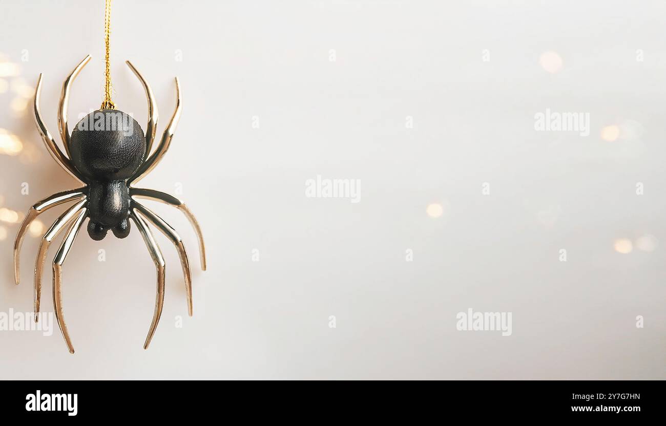 Halloween theme black and gold plastic faux spider hanging from gold ...