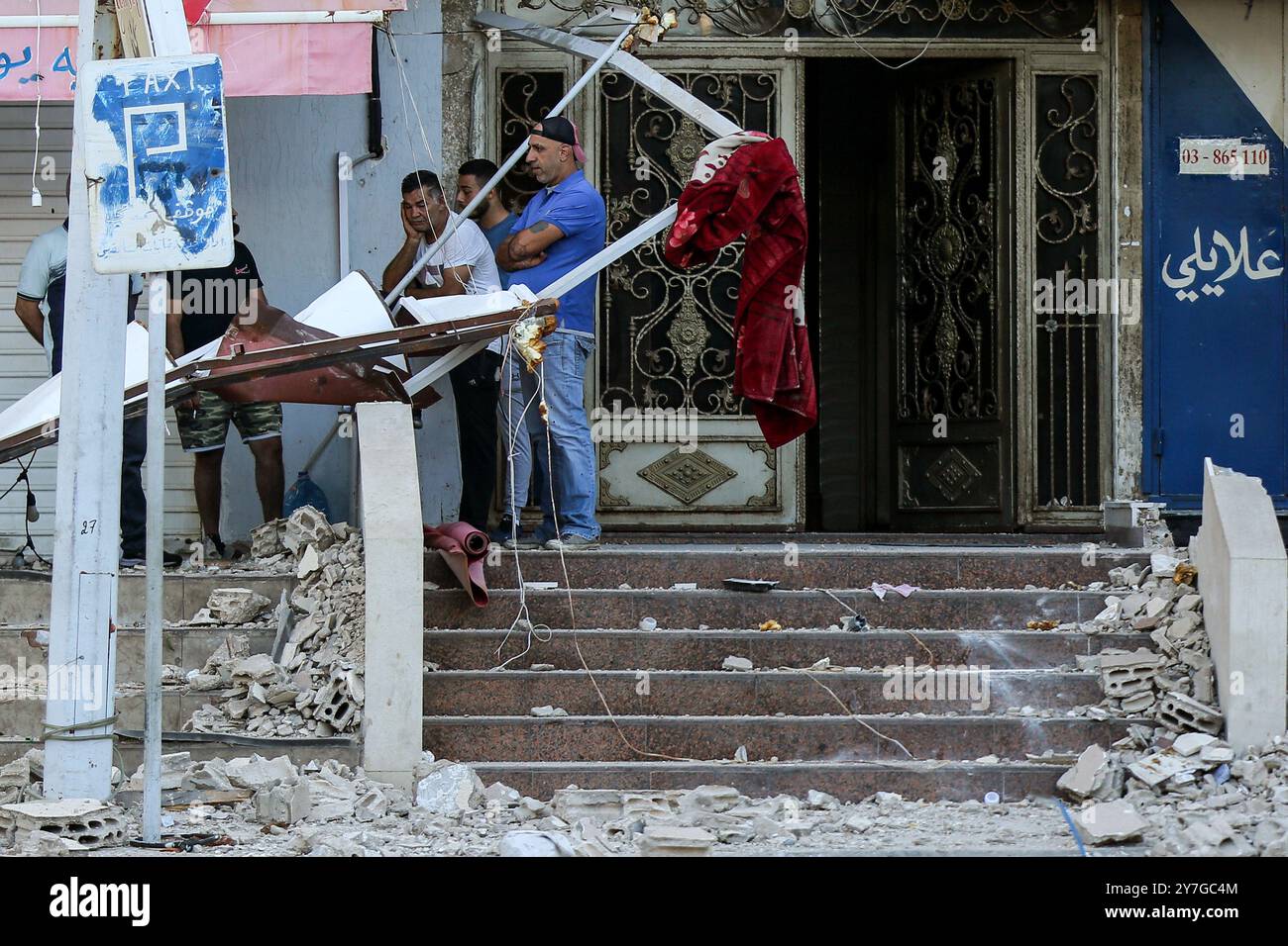 Beirut, Lebanon. 30th Sep, 2024. Lebanese people stand among the rubble ...