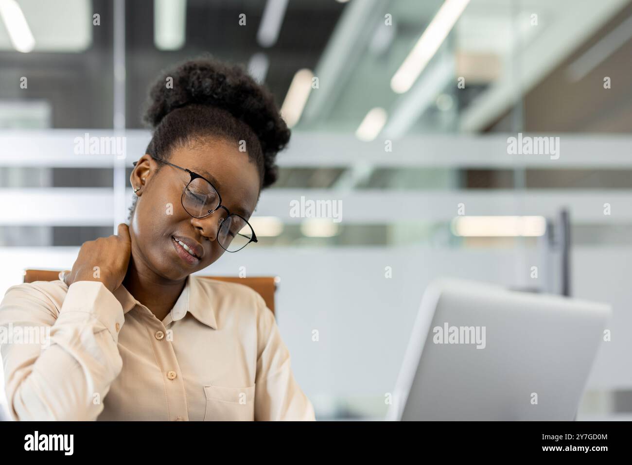Office worker appears stressed and uncomfortable, suffering neck pain ...
